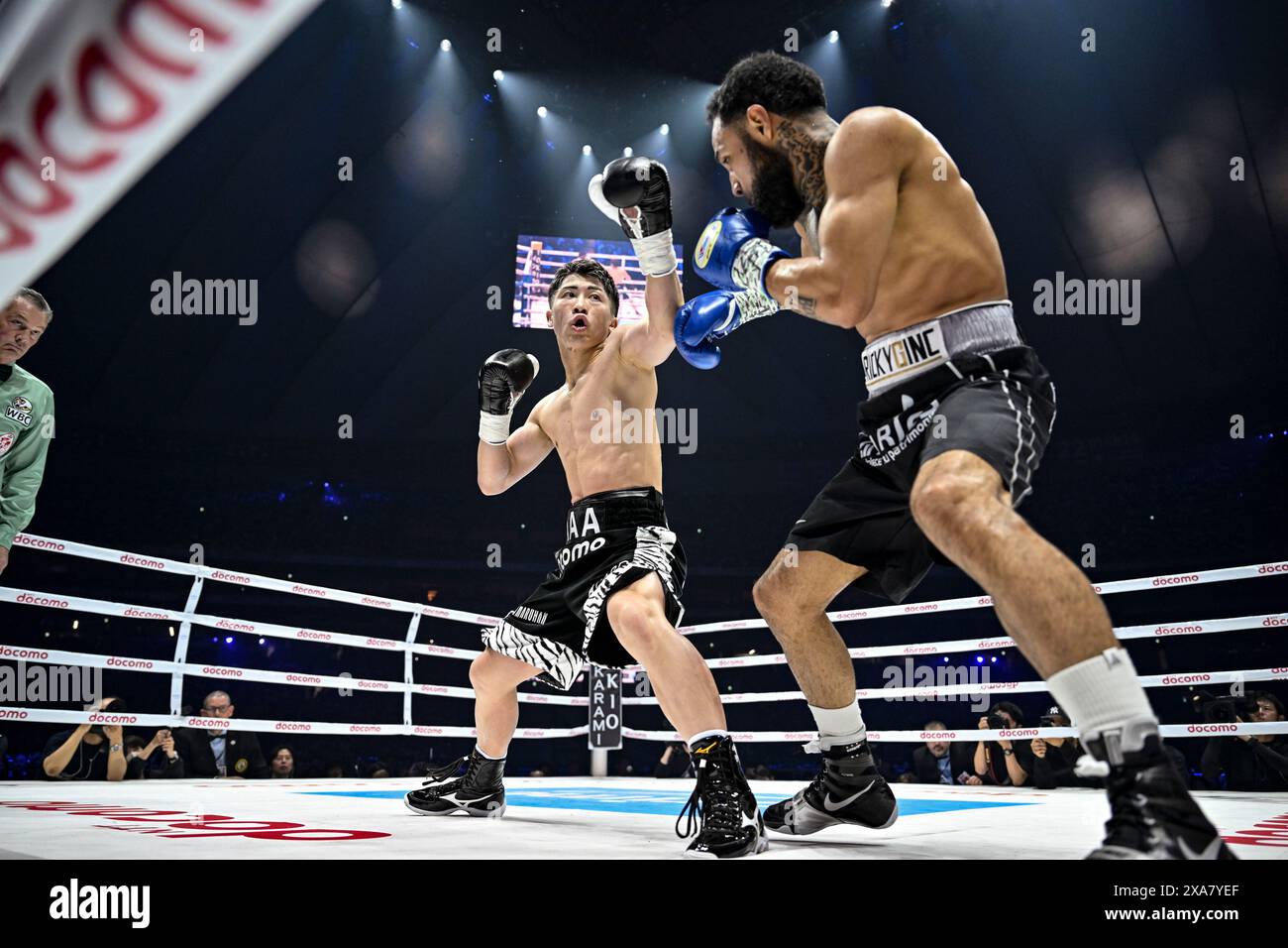 Naoya Inoue (blacck gloves) of Japan and Luis Nery (blue gloves) of Mexico compete during their ...
