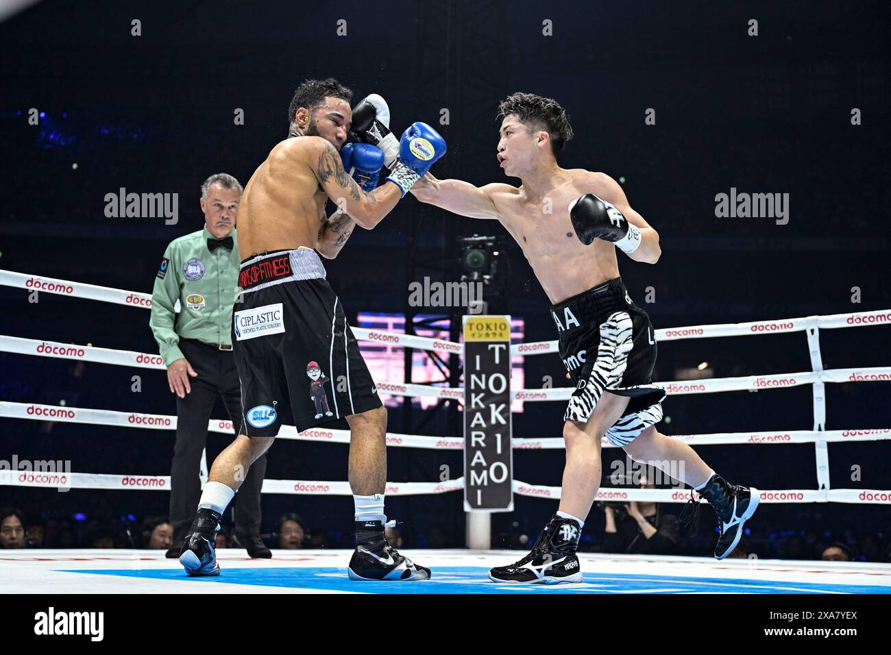 Naoya Inoue (blacck gloves) of Japan and Luis Nery (blue gloves) of Mexico compete during their ...