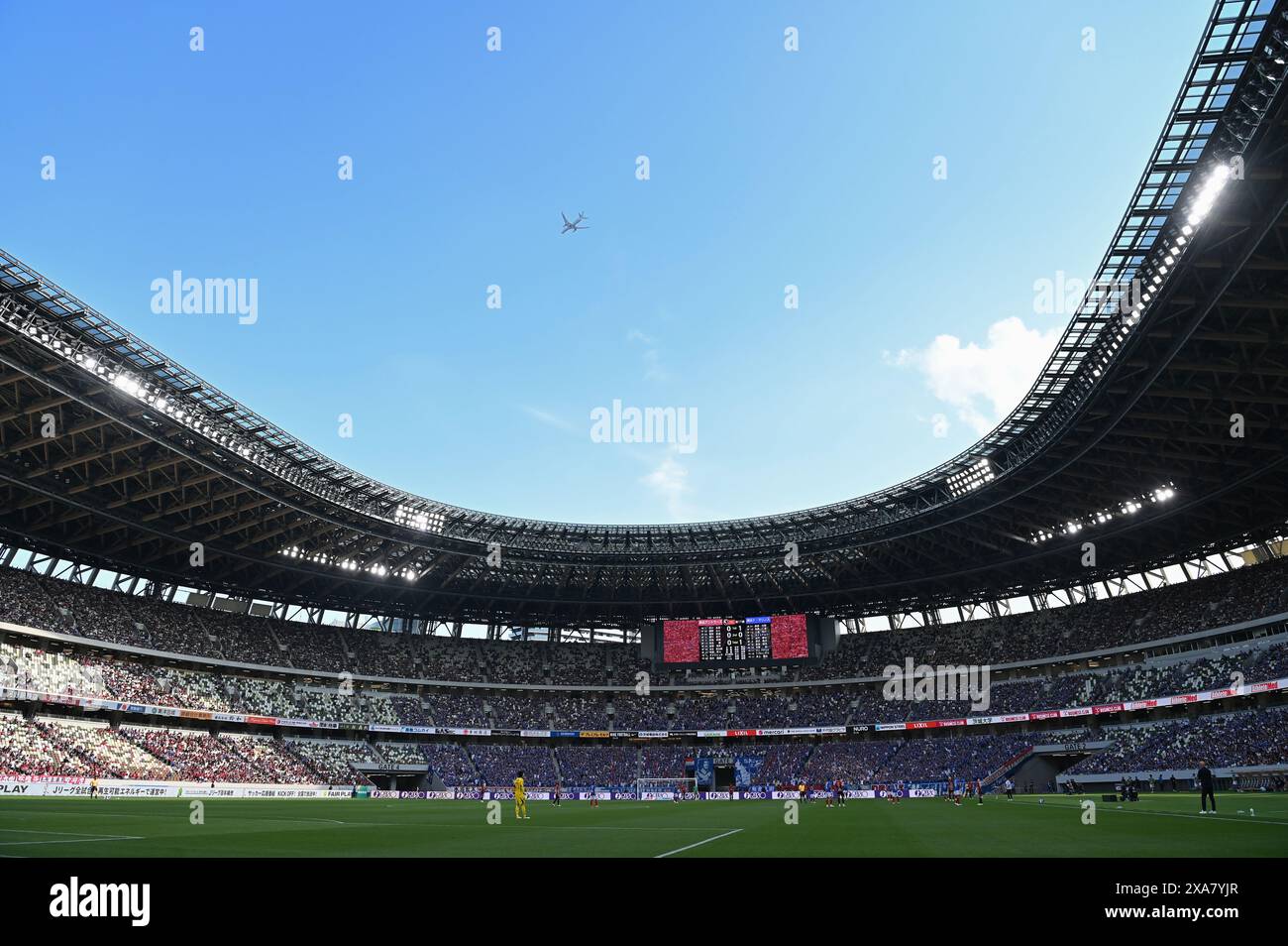 Tokyo, Japan. 1st June, 2024. A plane flies over the stadium during the ...
