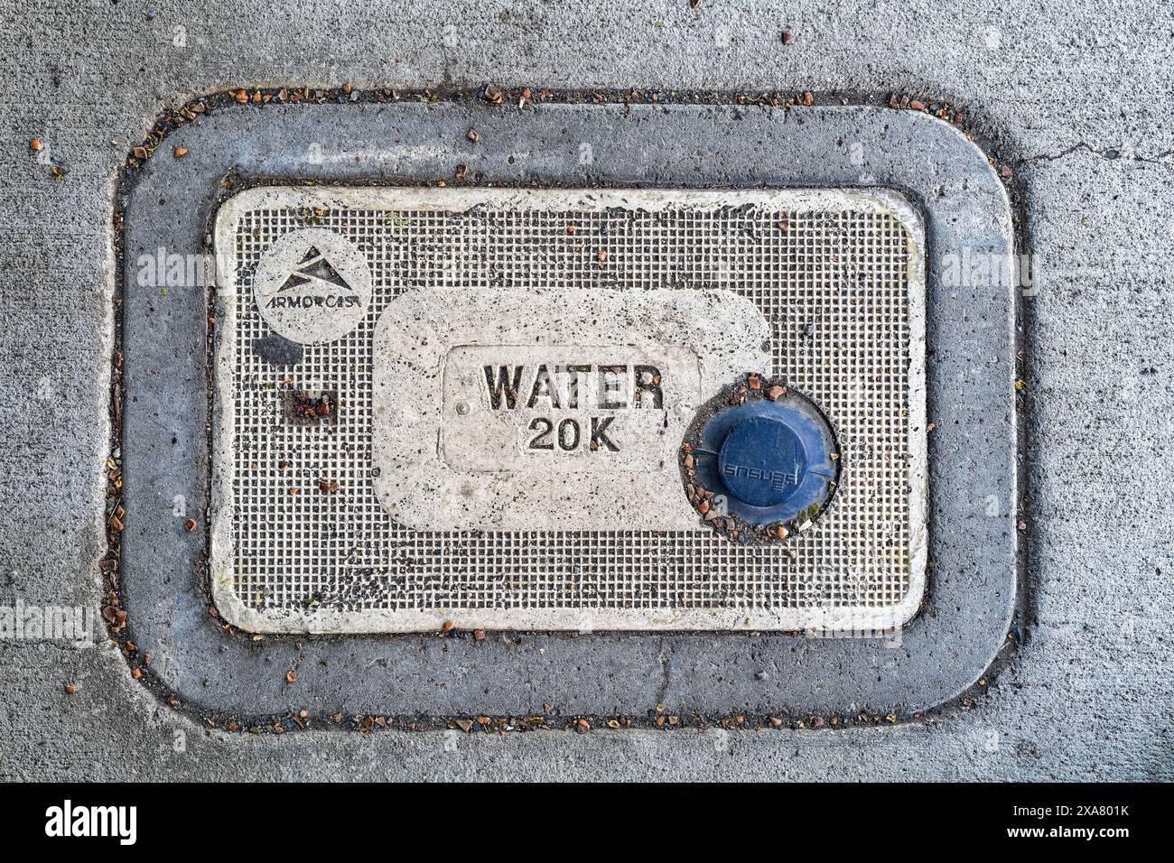 An Armorcast concrete water meter lid installed in the sidewalk at La ...