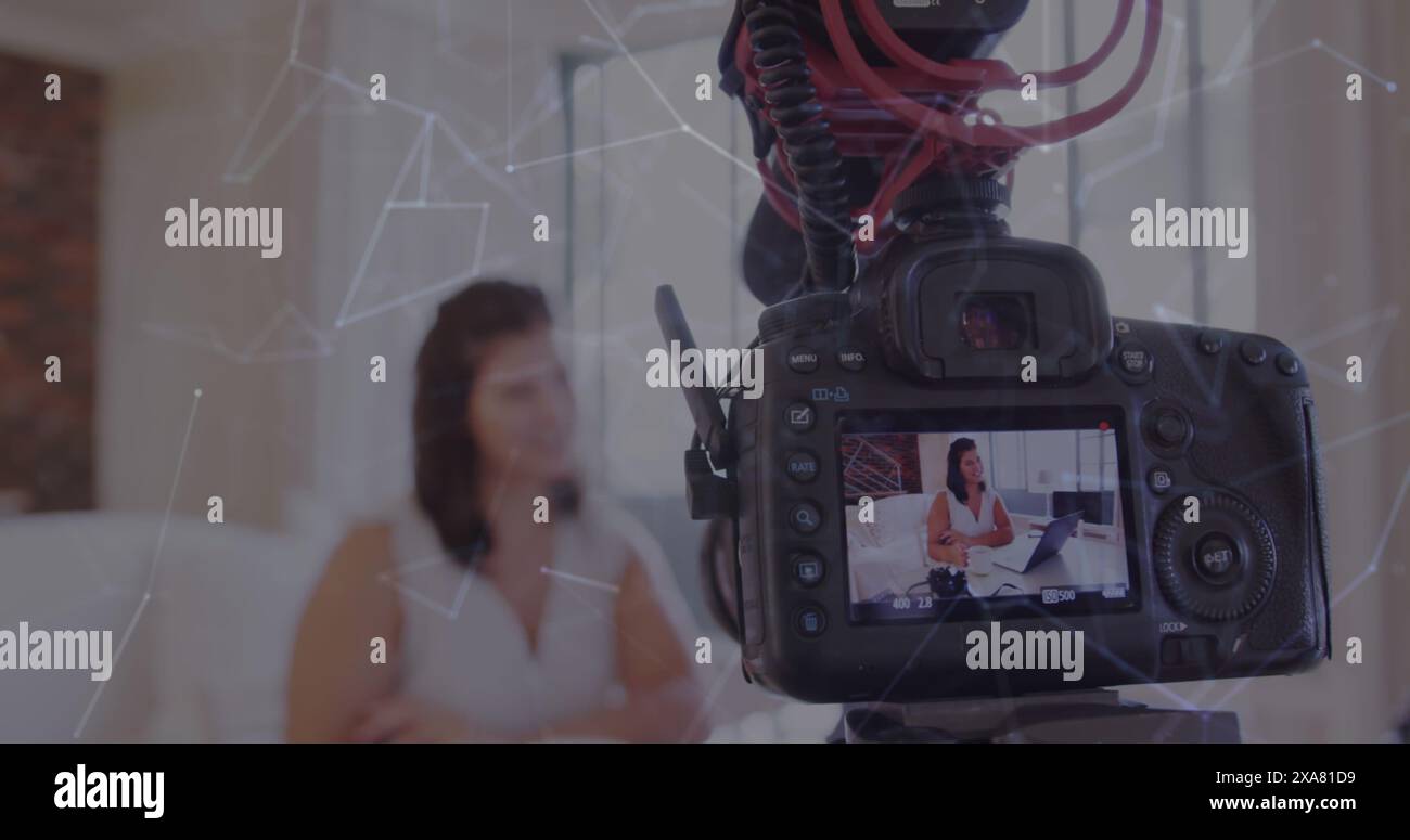 Image of network of connections over camera screen with female vlogger ...