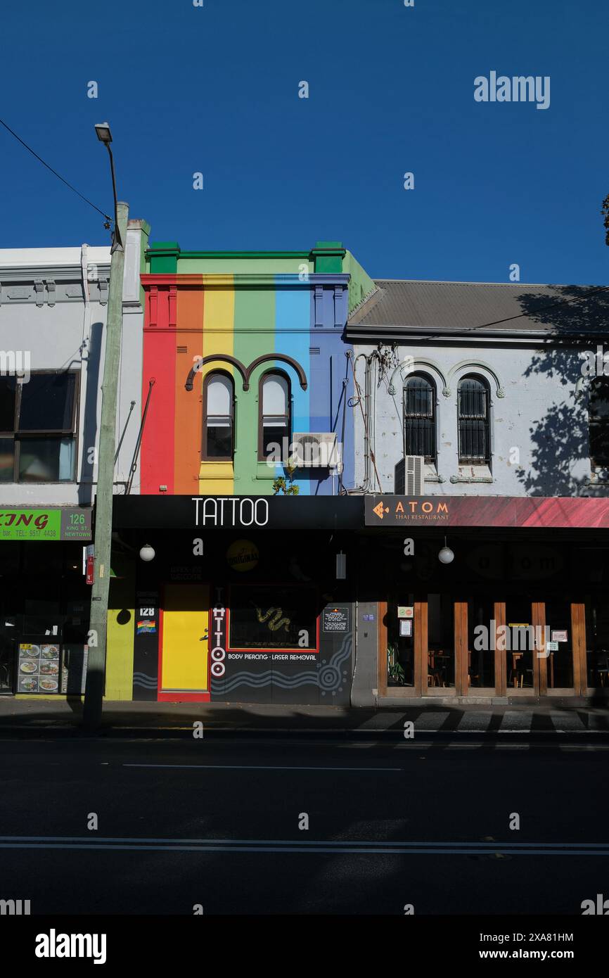 Tattoo shopfront painted in horizontal stripes of rainbow colours ...
