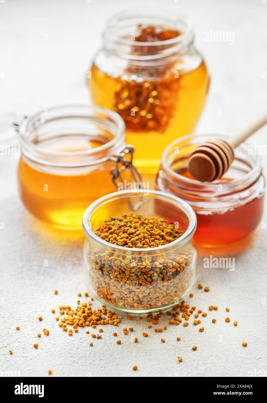 Raw organic bee pollen and honey in jars Stock Photo - Alamy