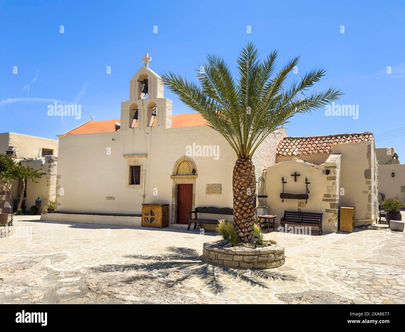 In the foreground cretan date palm (Phoenix theophrasti) behind it two-aisled church Monastery ...