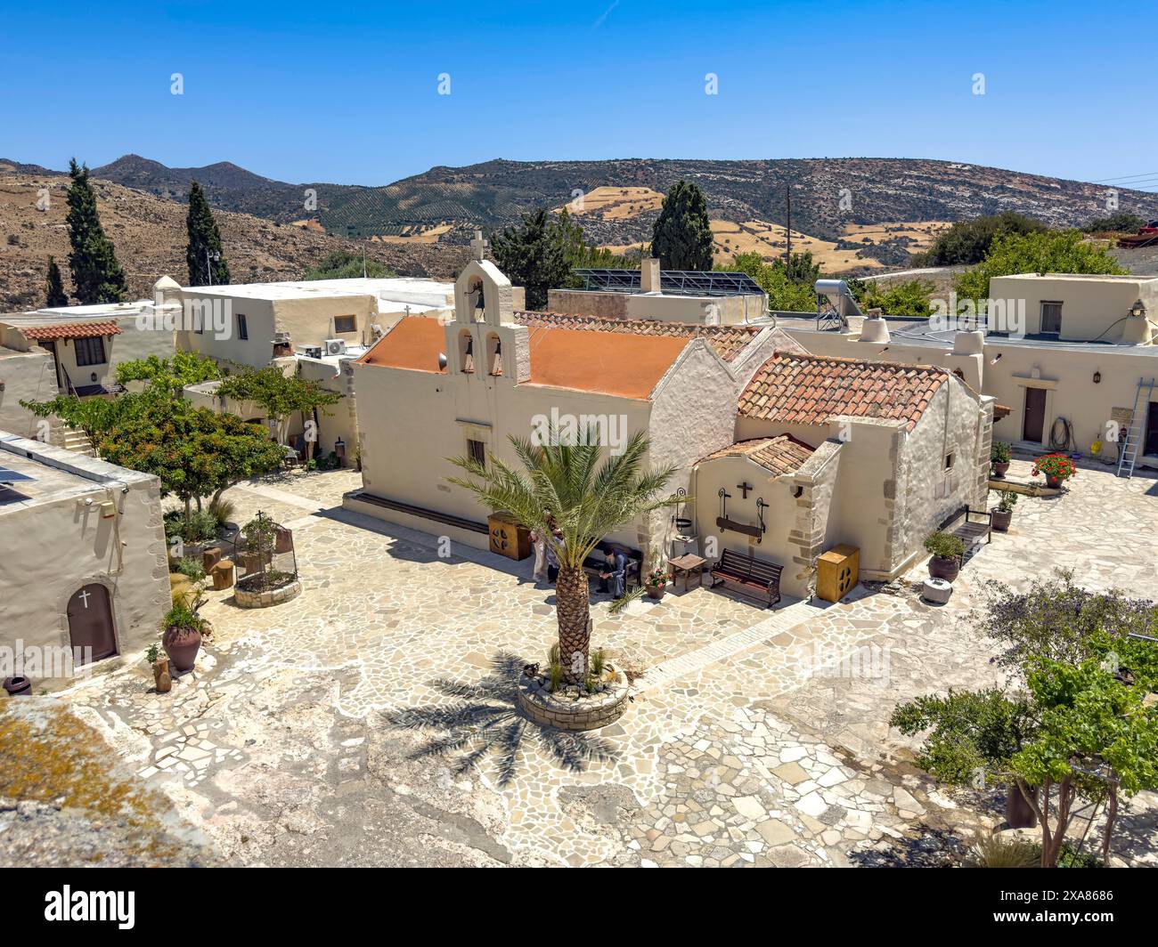 View of courtyard courtyard with Phoenix theophrasti of Odigitria Monastery in the centre two ...