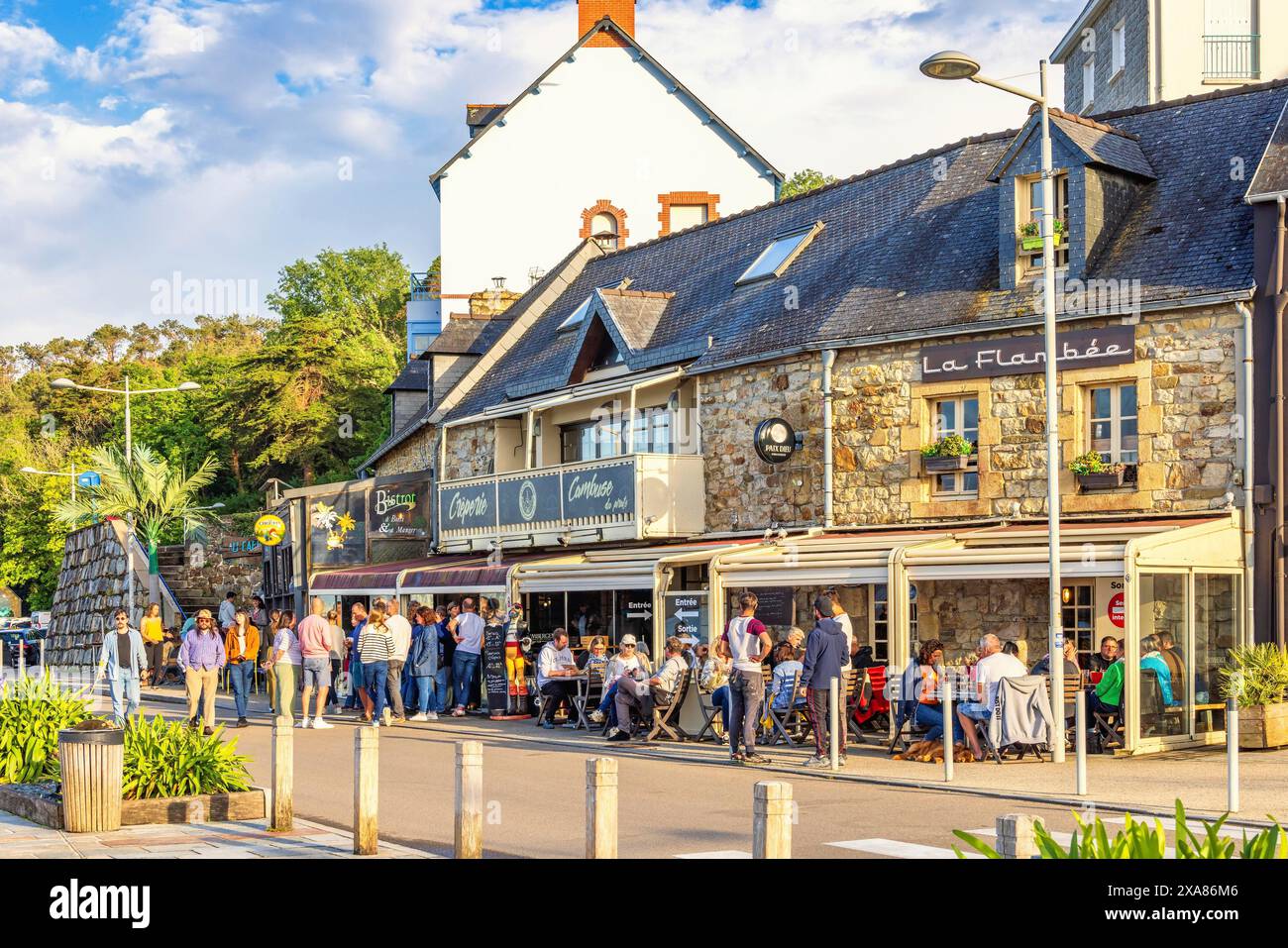 Restaurant with lot of people at a street in Morgat village on the ...