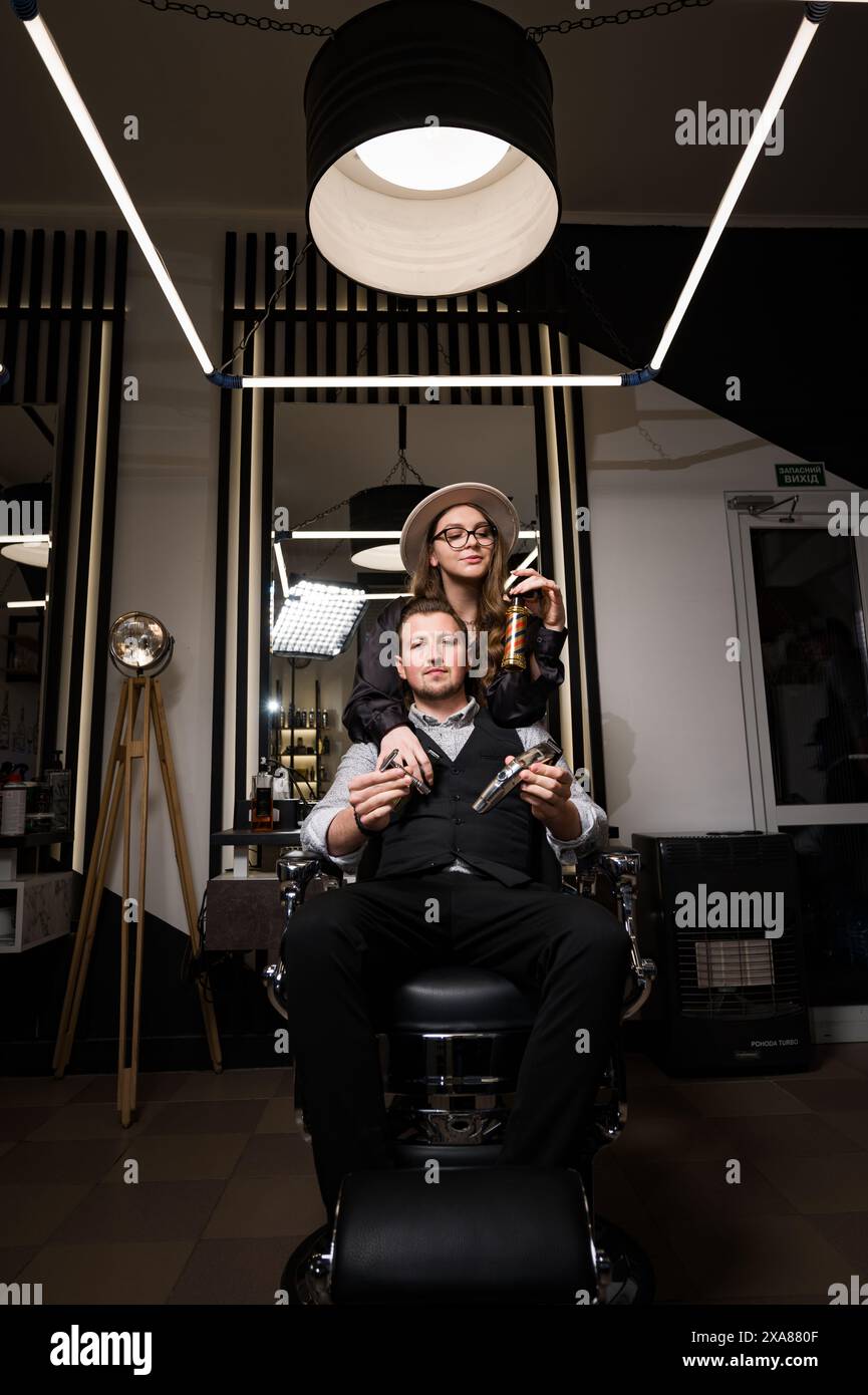 Girl sitting on barber chair hi-res stock photography and images - Alamy