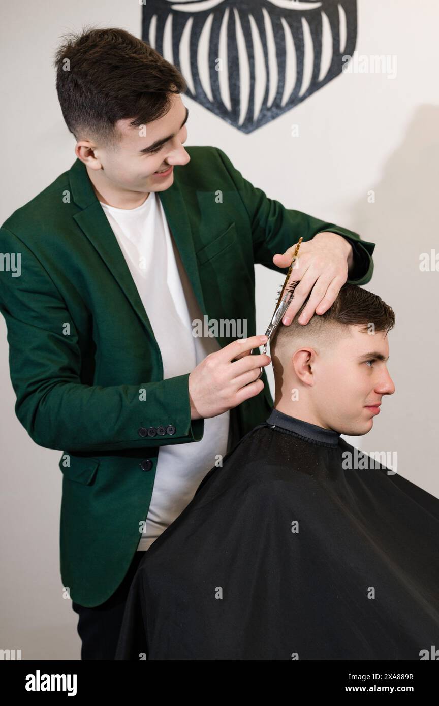 Haircut and alignment of the contour of the head with scissors. Short ...