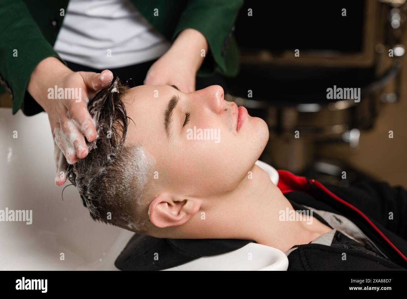 Barber shampooing washing a male client's head in the sink Stock Photo ...