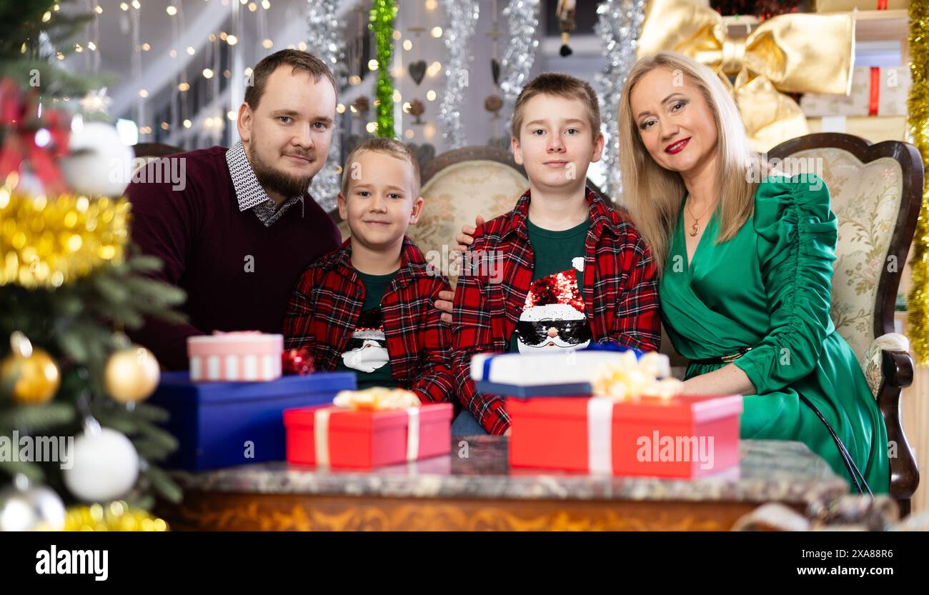 Portrait of happy family with two children celebrating Christmas next ...