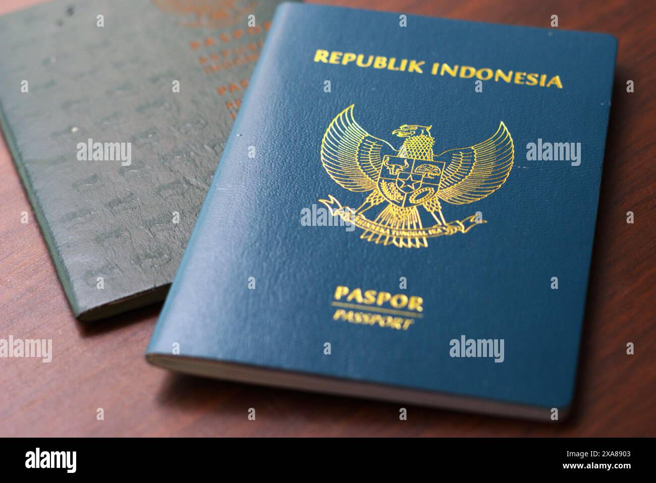 Indonesian passport on a wooden background, travel and immigration ...