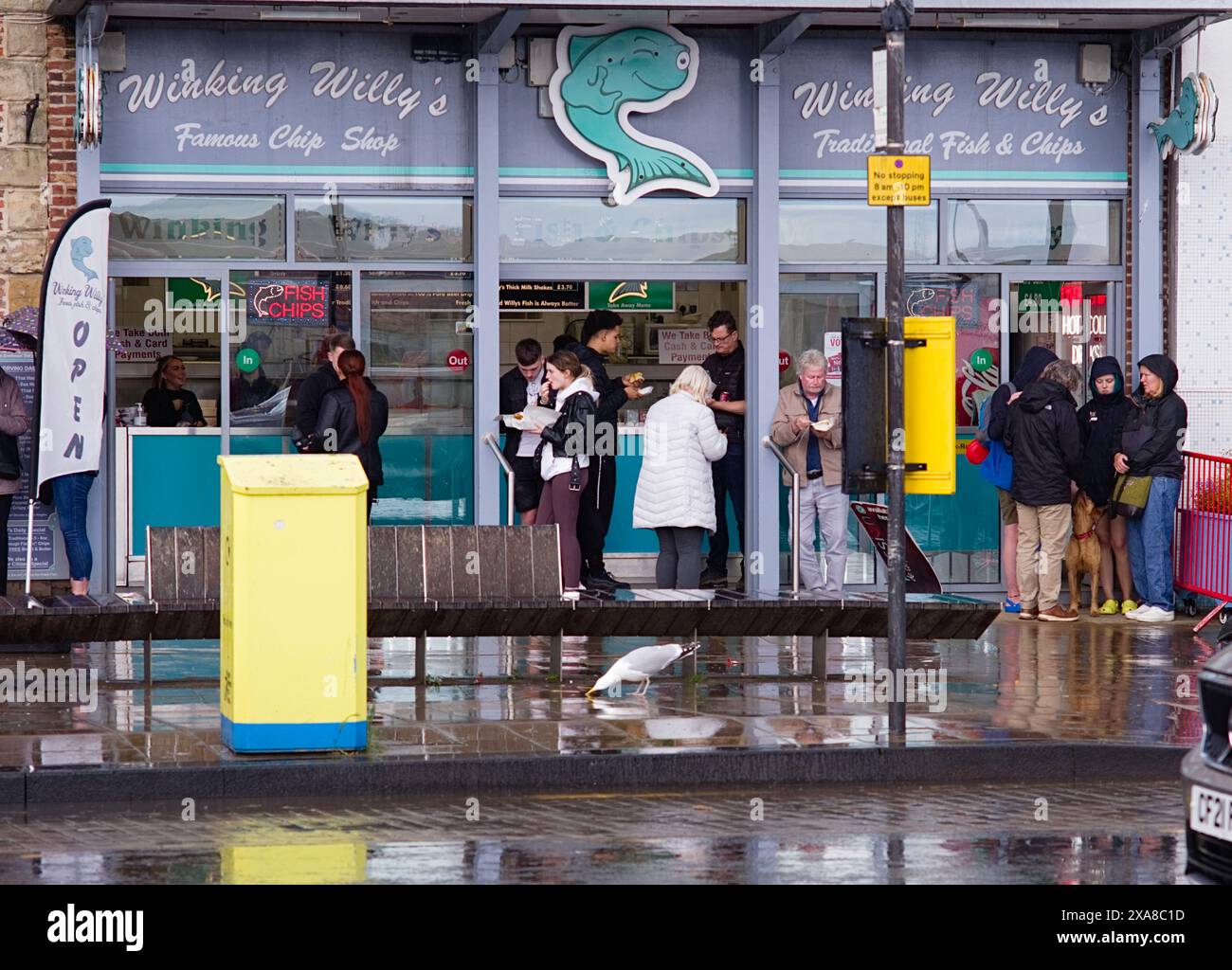 People sheltering at Winking Willy's fish and chip shop during a heavy ...