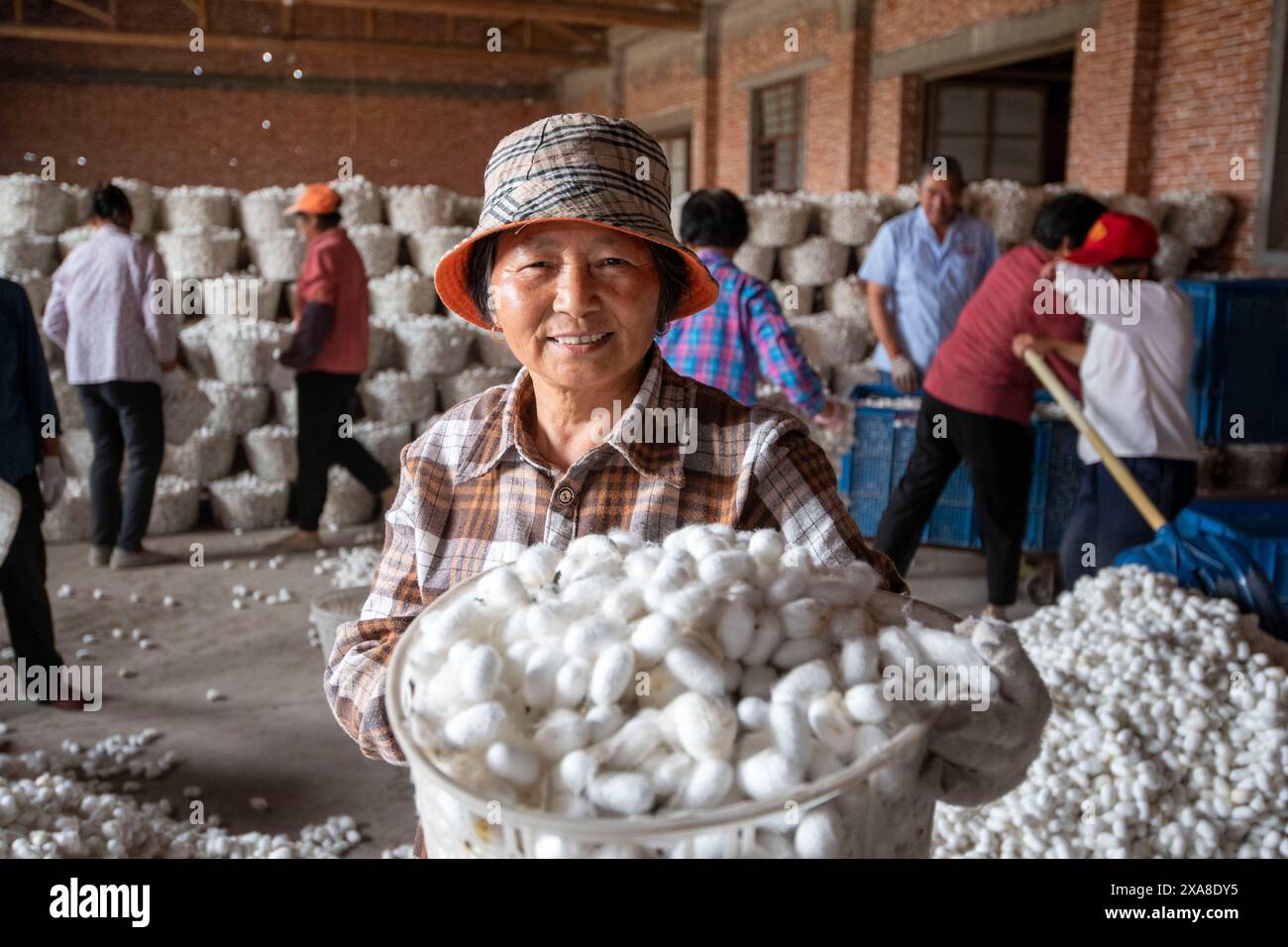 HAI'AN, CHINA - JUNE 4, 2024 - A staff member displays purchased ...