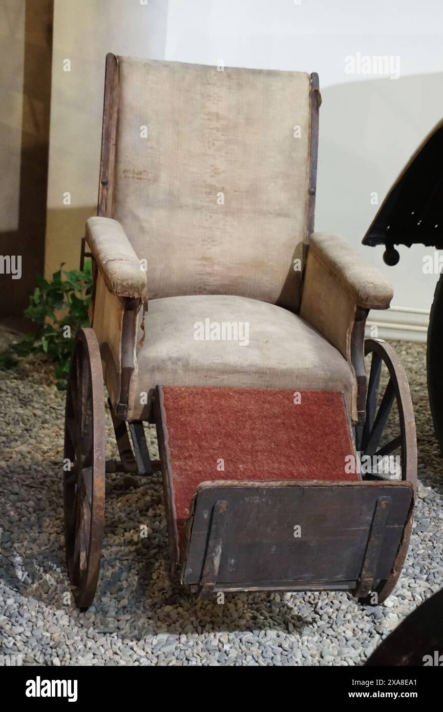 very old wheelchair as very nice technology history Stock Photo - Alamy
