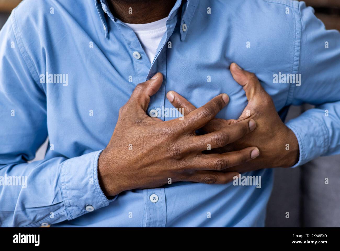 Man chest pain heart attack blue shirt hi-res stock photography and ...