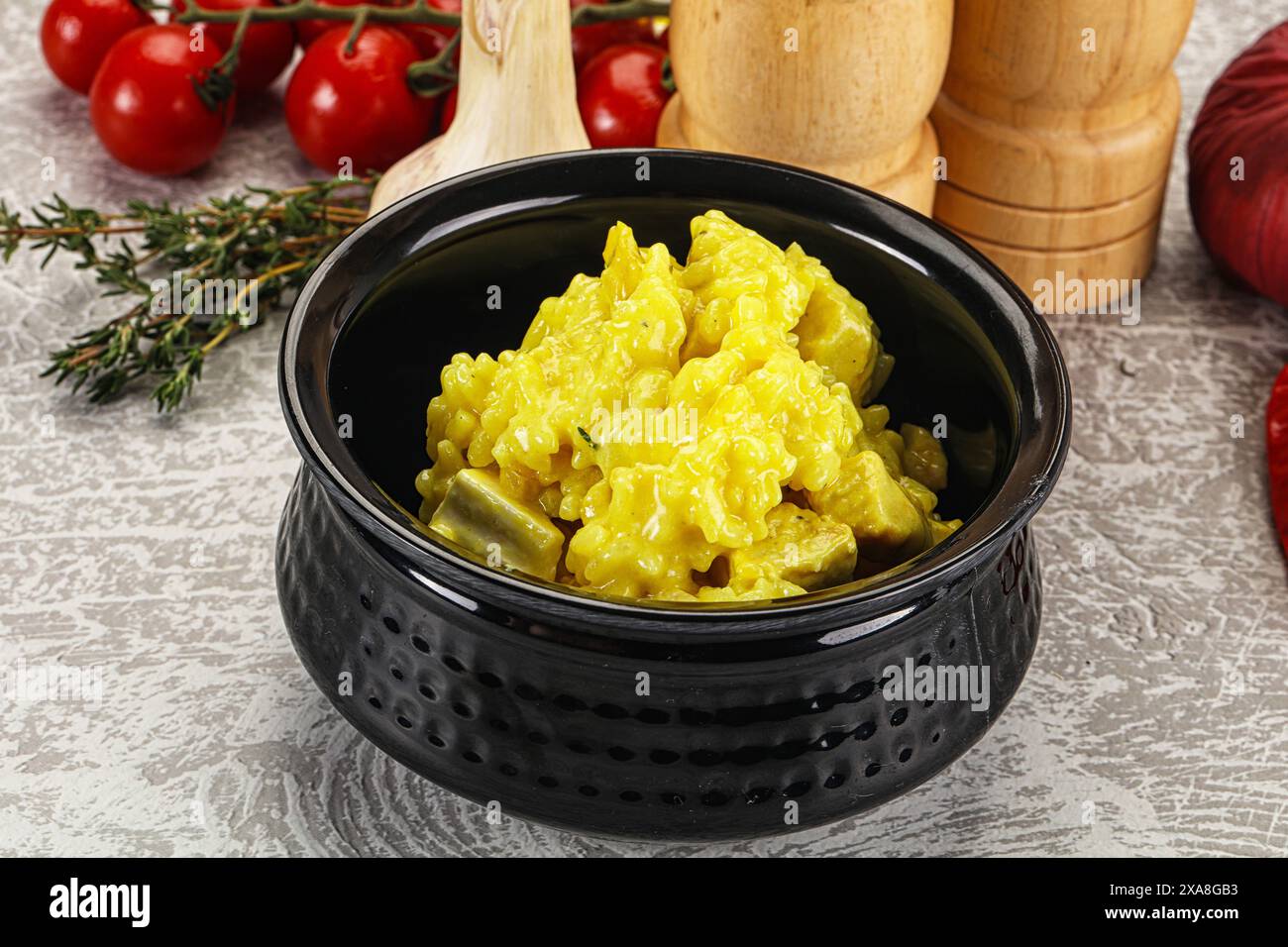 Italian cuisine - yellow risotto with chicken and soft cheese Stock ...