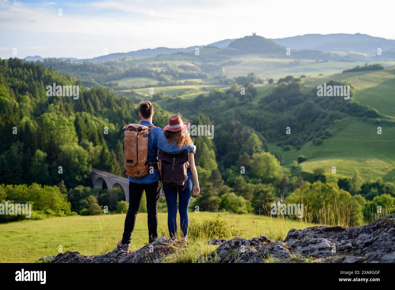 Travellers couple hiking on easy trail in nature with backpacks. Young ...