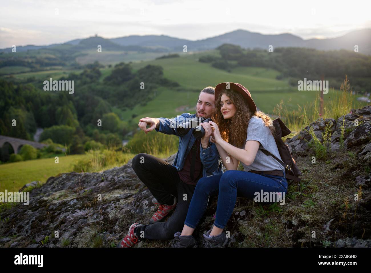 Travellers couple hiking on easy trail in nature with backpacks. Young ...