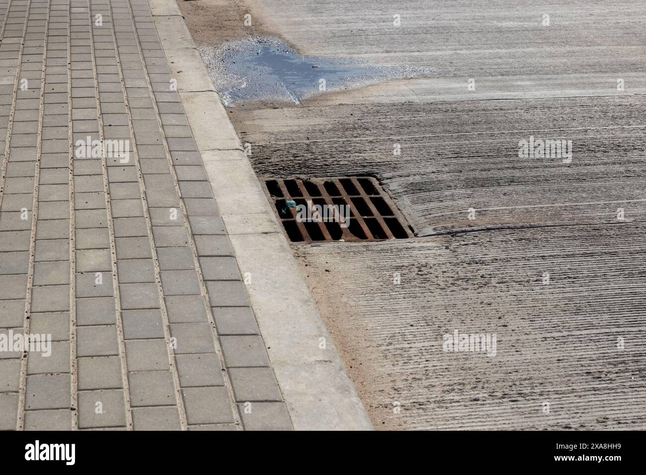 A drainage system on the side of a road where water flows out ...