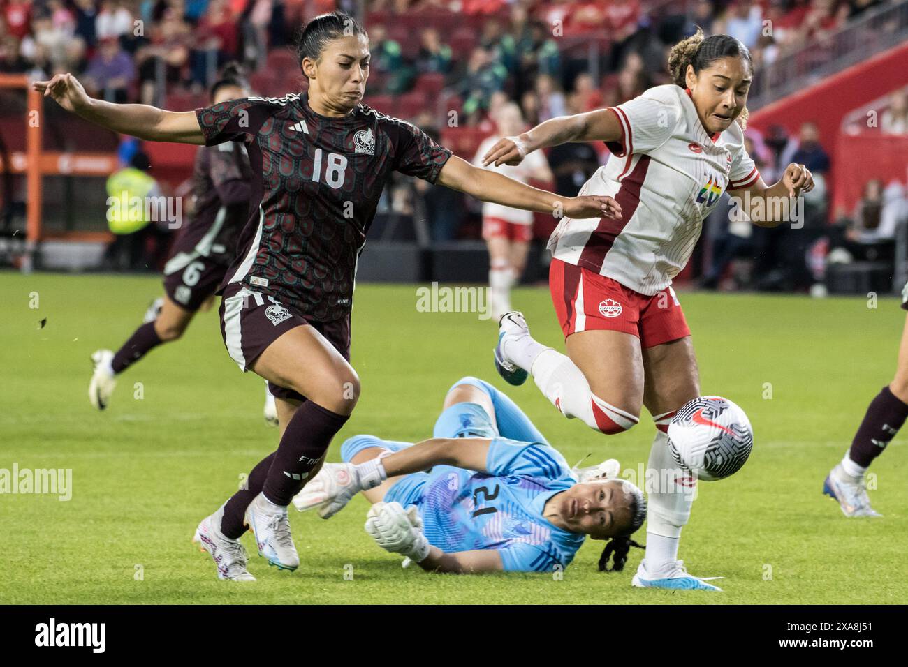 Olivia Smith #26 (R) of Canada, Reyna Reyes #18 (L) of Mexico and ...