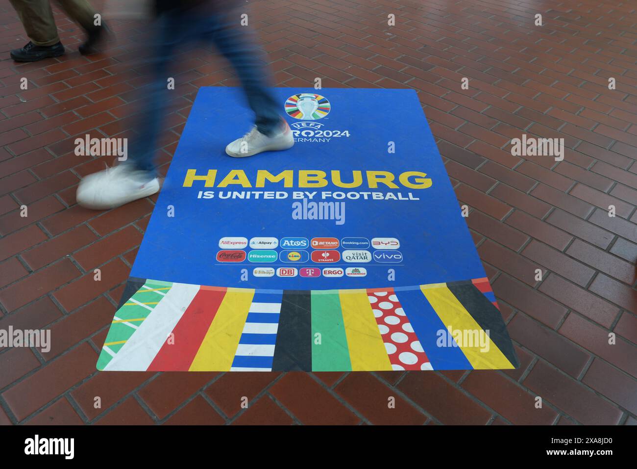 Hamburg, Germany. 05th June, 2024. Passers-by walk over a Euro 2024 ...