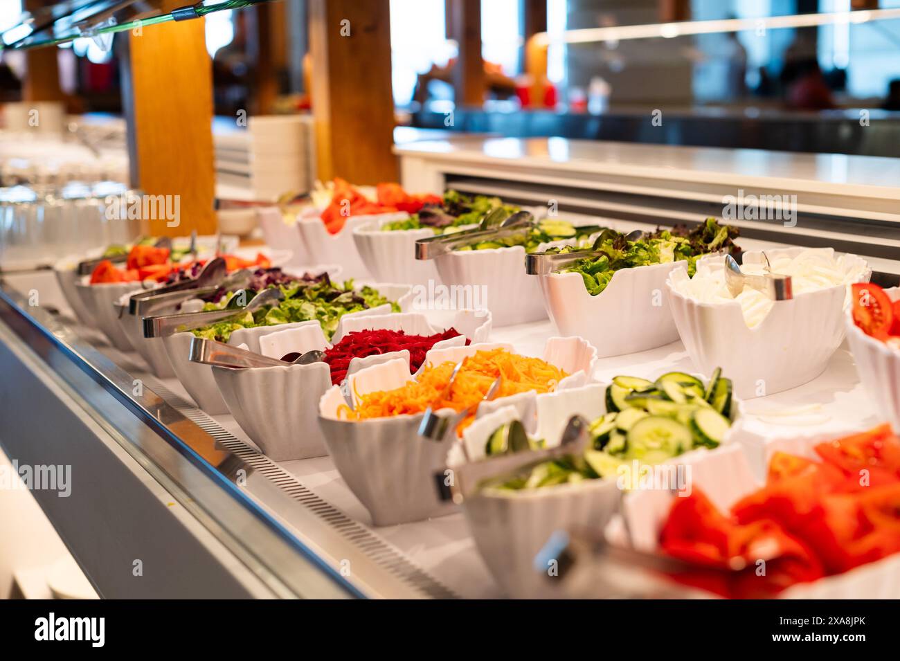 A salad bar with many different types of vegetables and fruits. The ...
