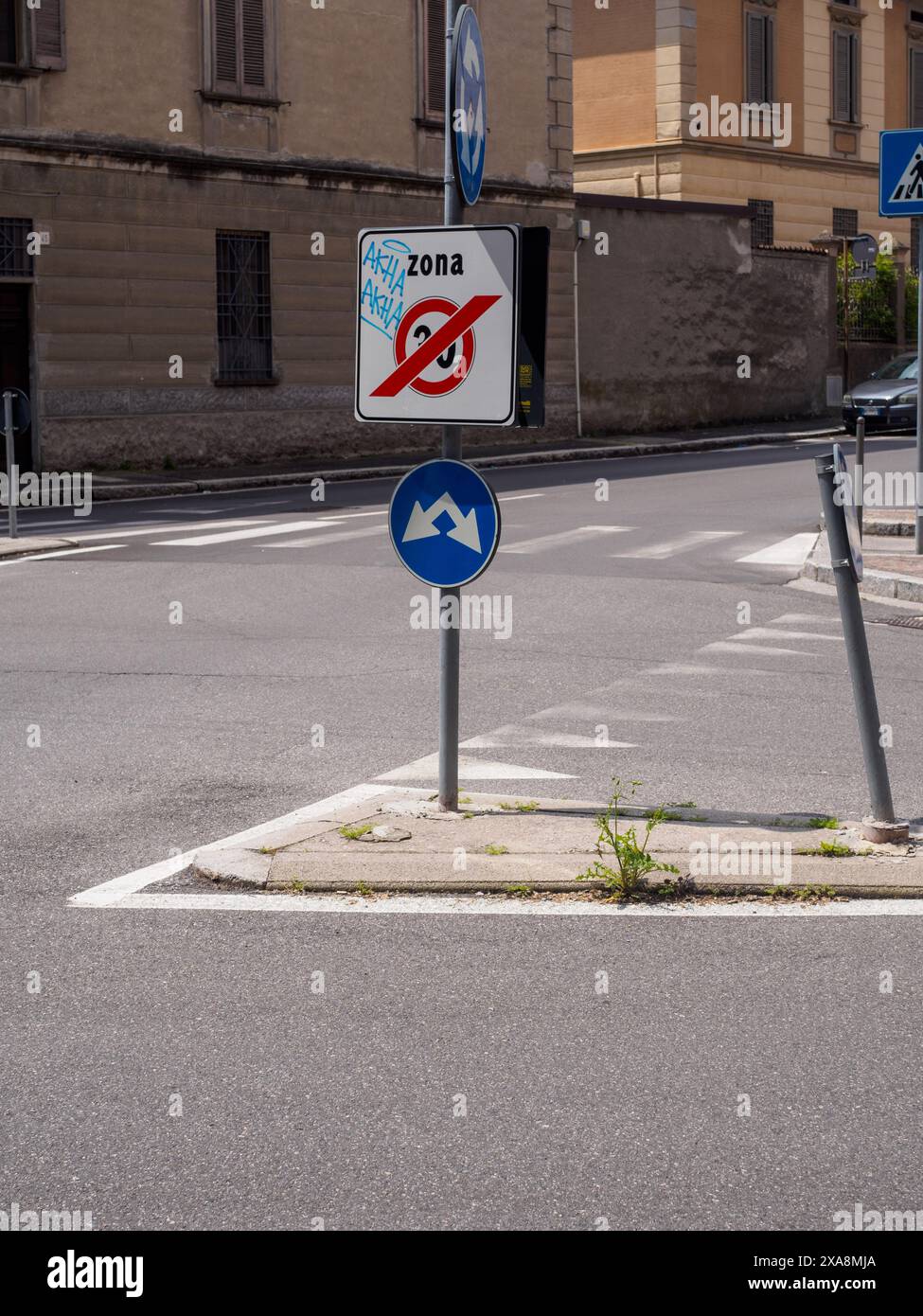 Cremona, Italy - May 27th 2024 Showing a no parking sign defaced with ...