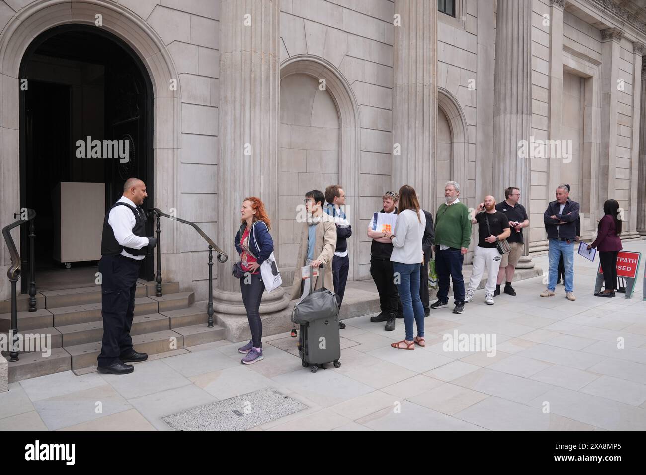 People queue outside the Bank of England, London, on the day the new ...