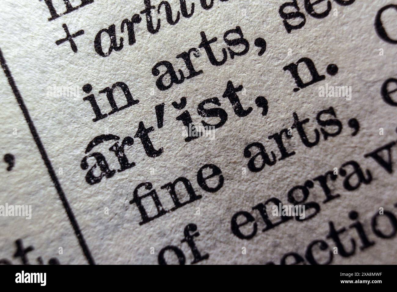 Word artist on dictionary page, macro close-up Stock Photo - Alamy