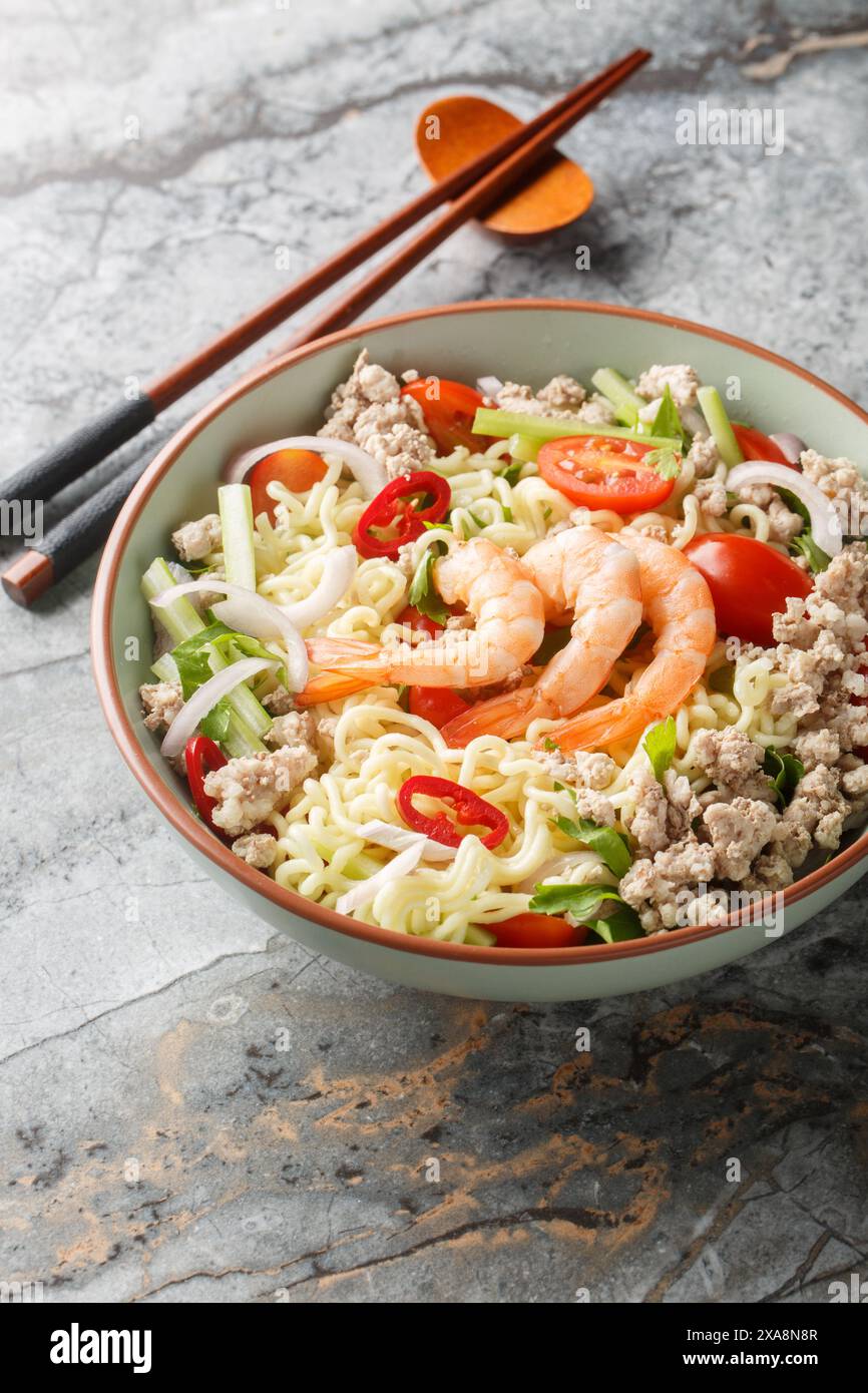 Yum Mama Thai Instant Noodle Salad closeup on the plate on the marble ...