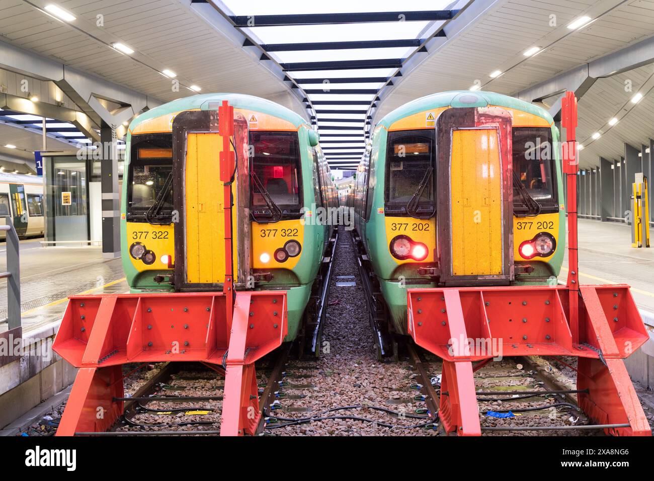 two southern railway trains stopped behind train buffer stops at London ...
