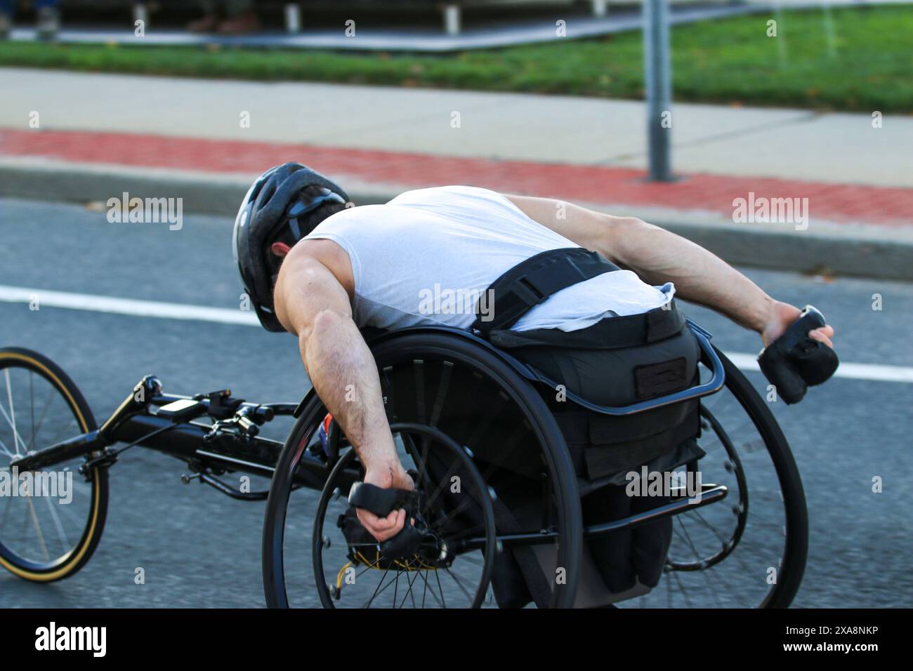 Close up of a side view of a man competing on a wheelchair during a ...