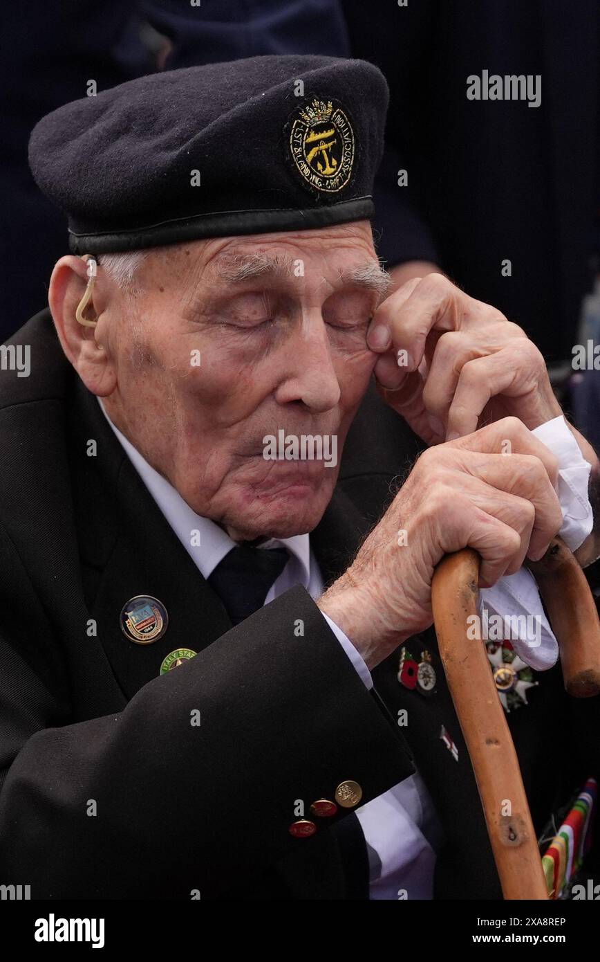D-Day veteran John Dennett, 99, wipes his eye at the statue of Field ...