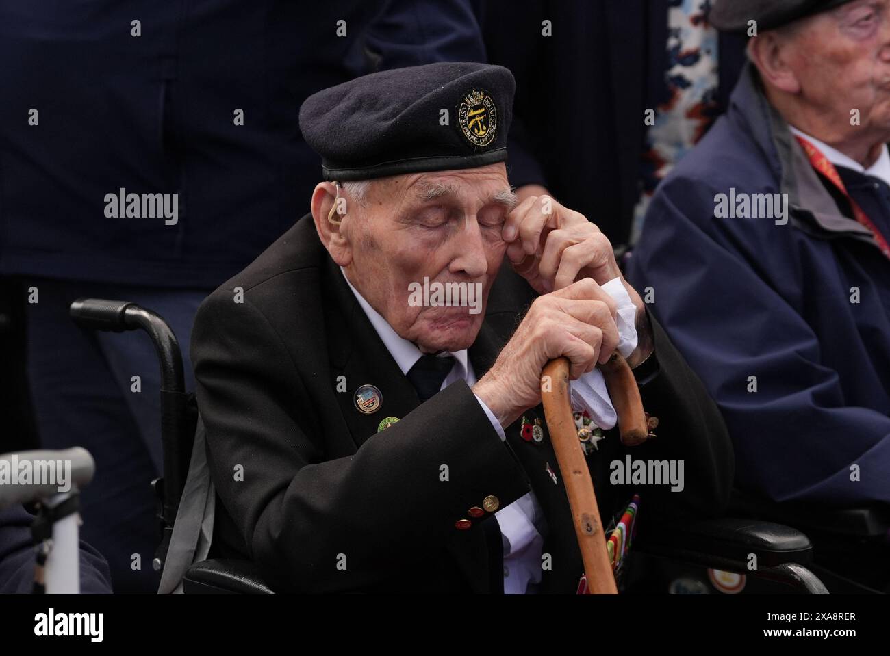 D-Day veteran John Dennett, 99, wipes his eye at the statue of Field ...