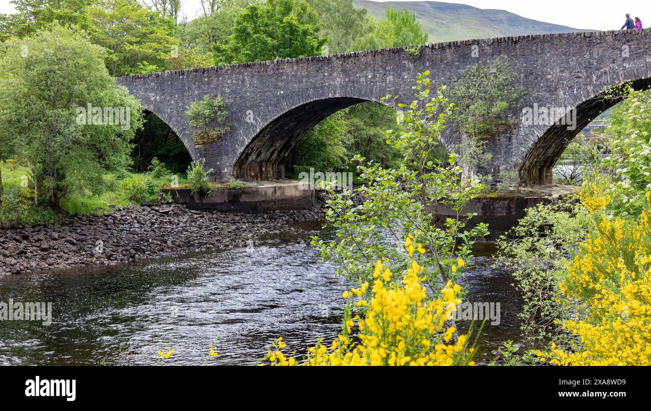 RIVER TUMMEL, PERTHSHIRE, SCOTLAND, UK, MAY 25. Old stone bridge over ...
