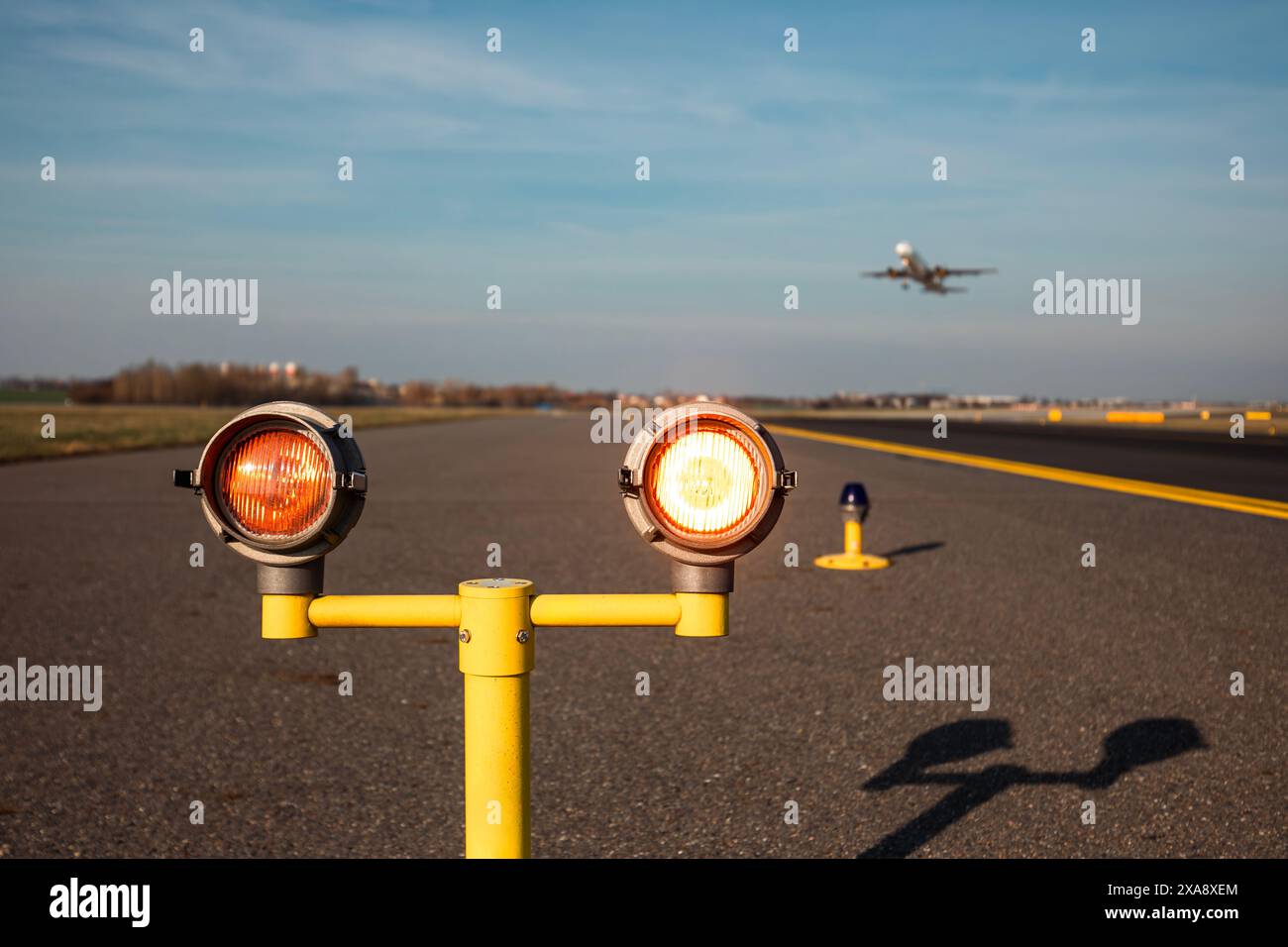 Traffic at airport on sunny day. Close-up of safety lights warning of ...