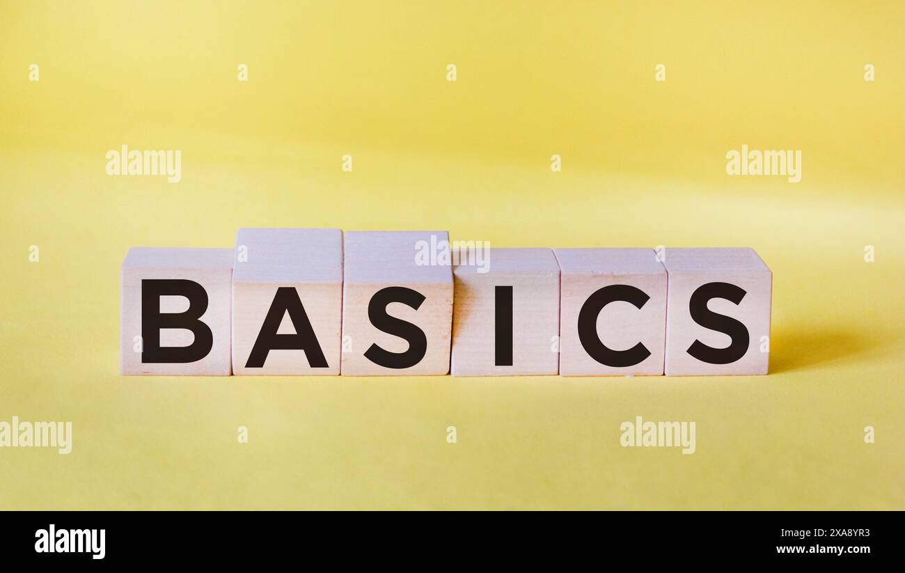 The word FUNDAMENTALS made from building blocks on a yellow background ...