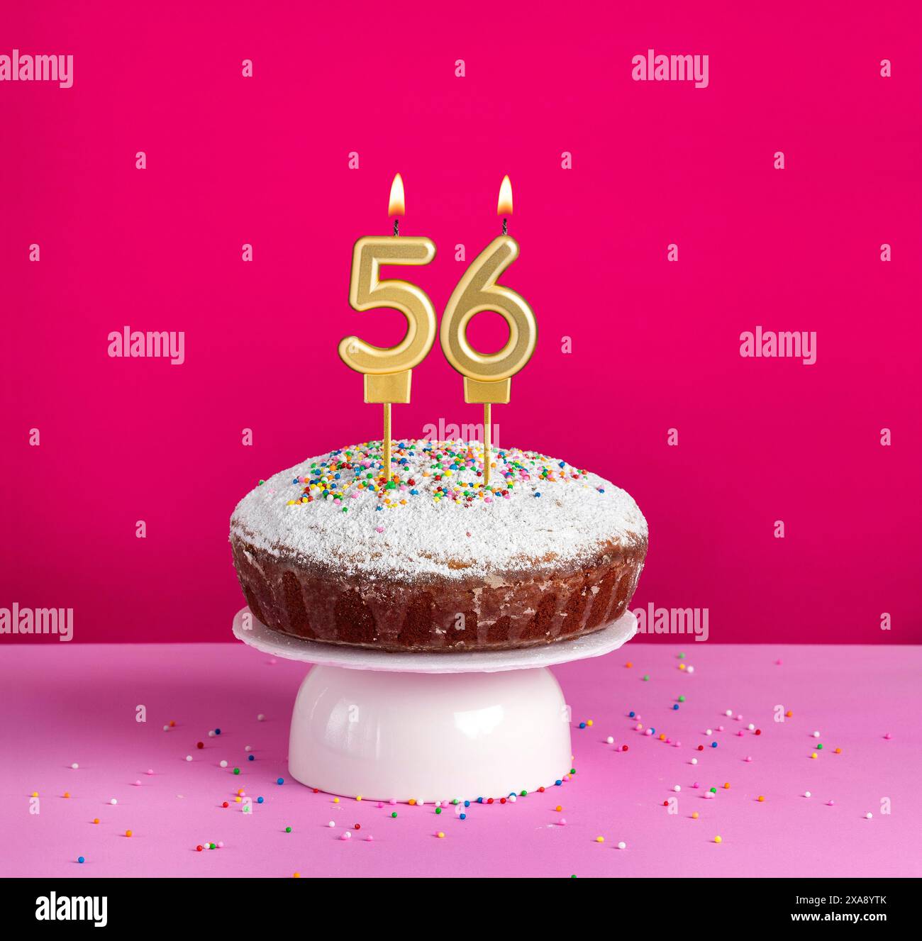 Lighted birthday candle number 56 - Birthday card on pink background ...