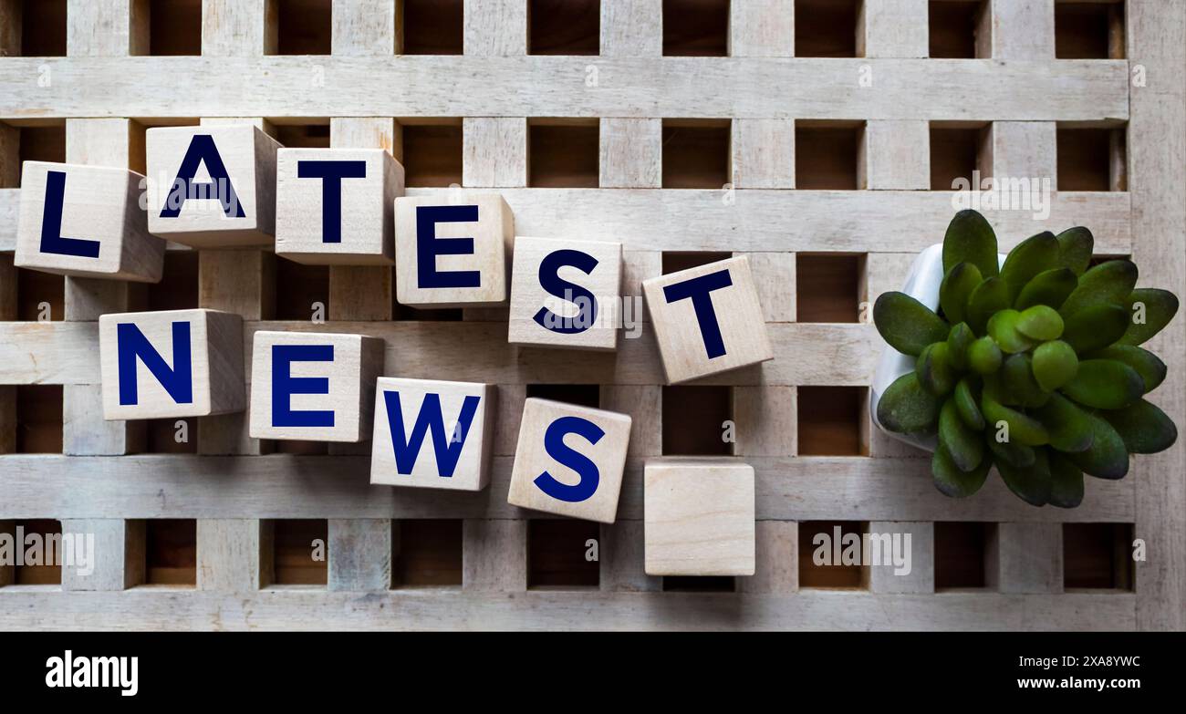 Latest news words on wooden blocks on a beautiful background. Fake or ...