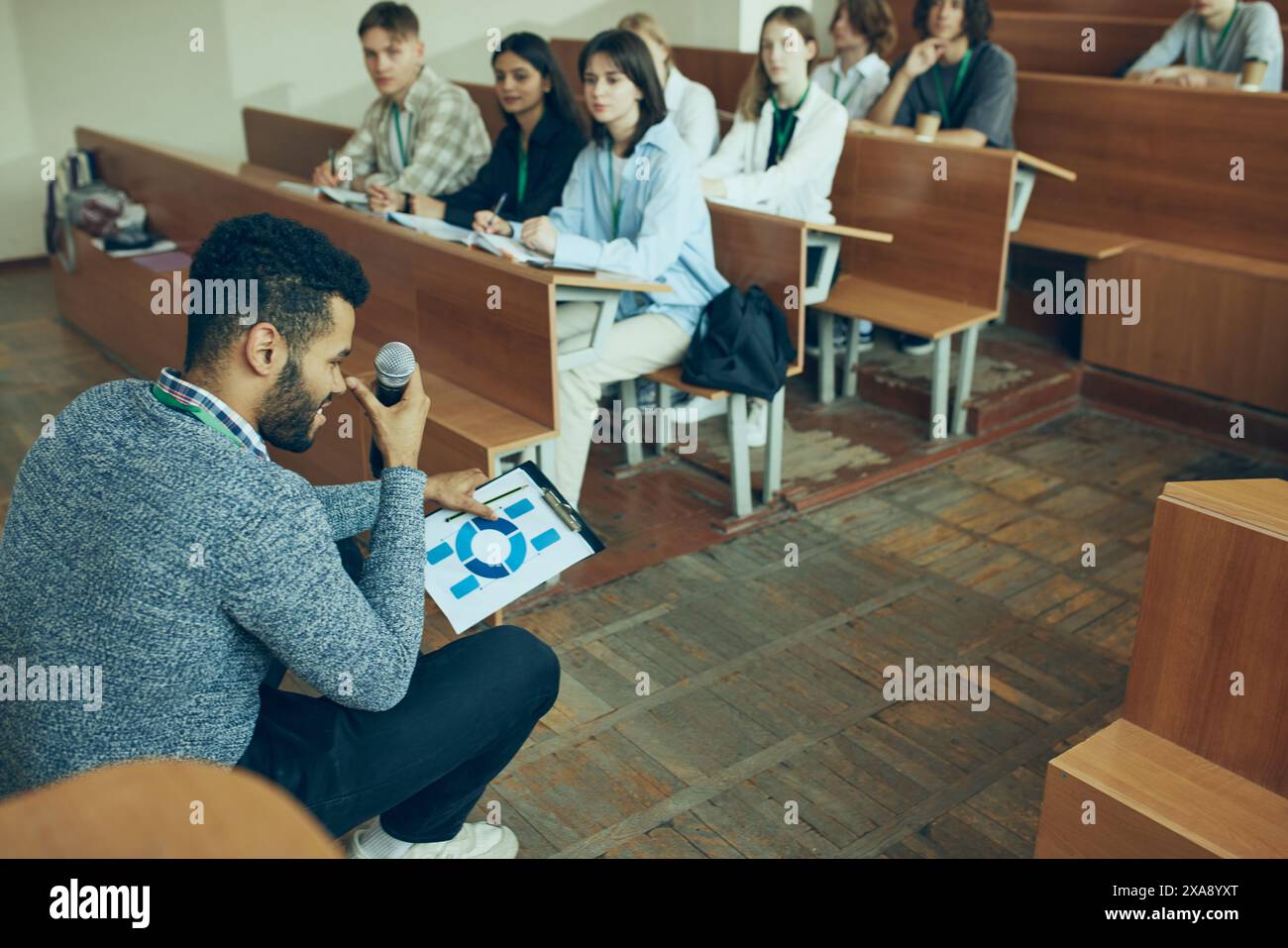 Business and analytics lesson. Young teacher leading lesson to group of ...