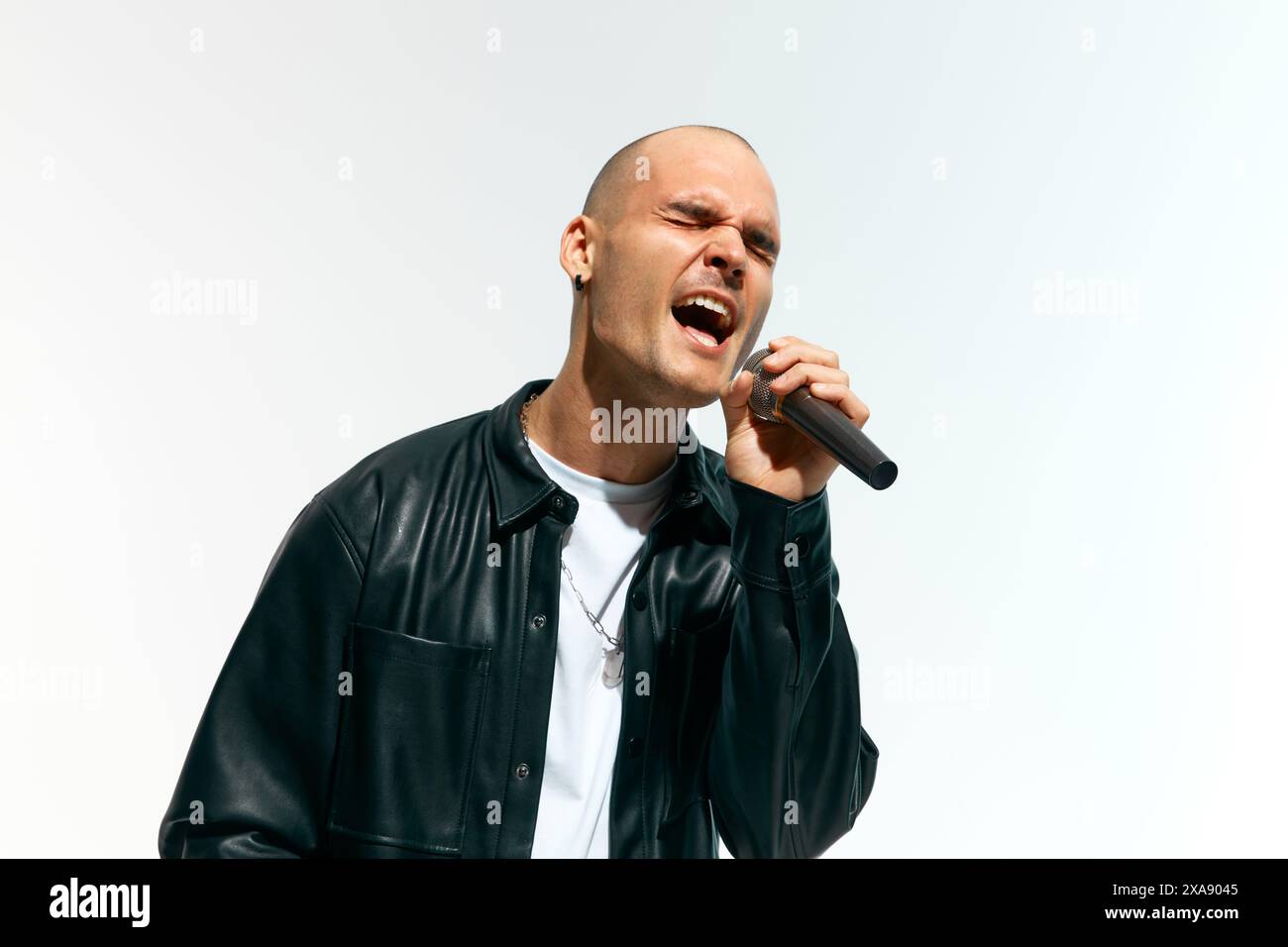 Portrait of talented young man, artistic vocalist captured performing ...
