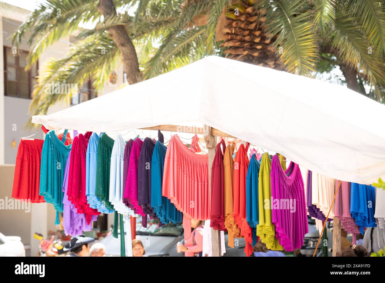 traditional colourful Bolivian skirts hung in a market for sale ...