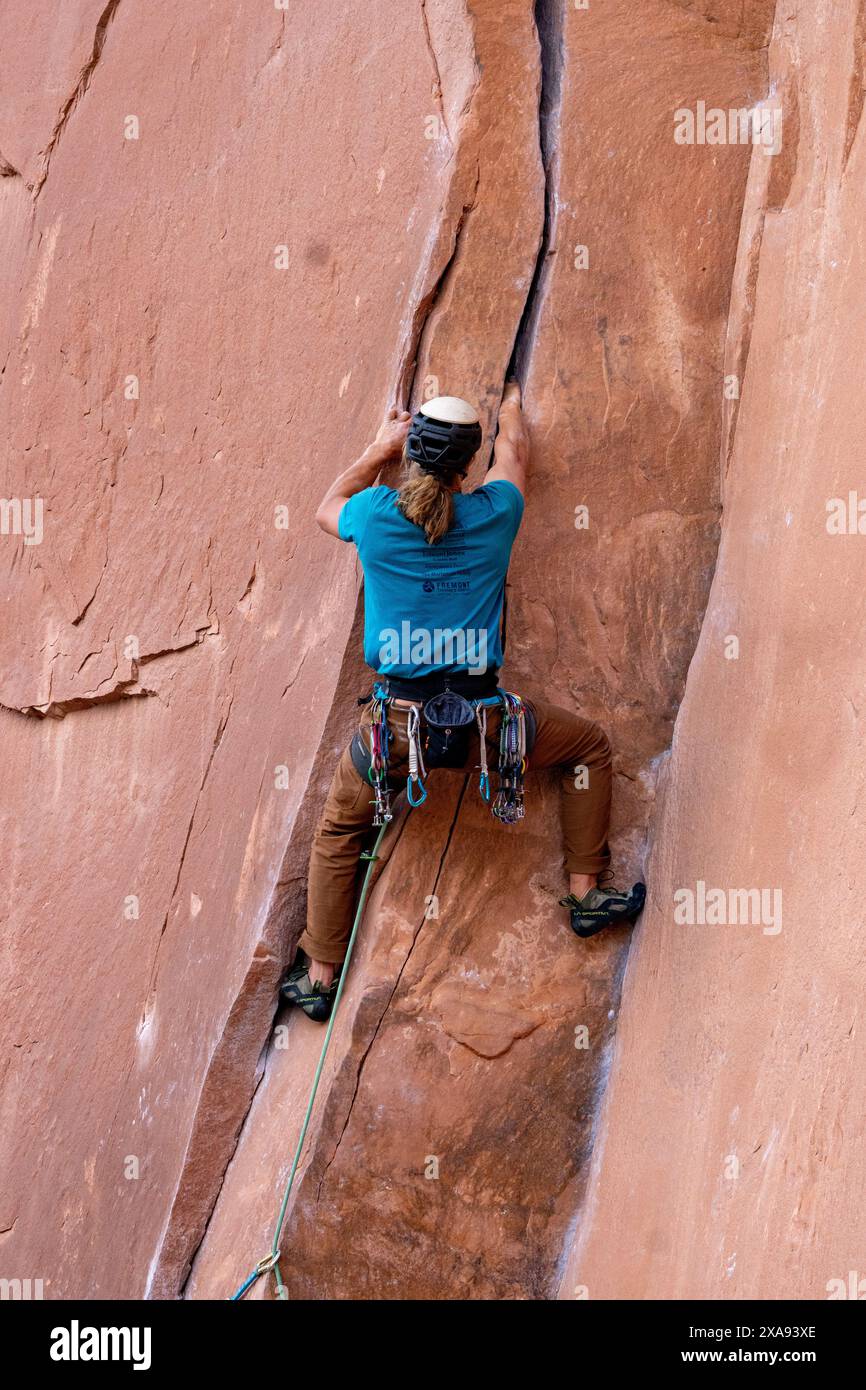 A lead climber using the technique of jamming to support himself during ...