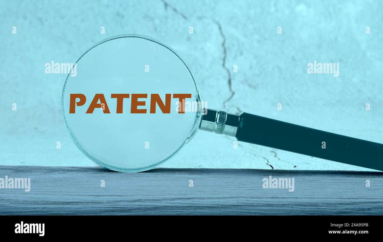 Business Team Concept. Word PATENT written through a magnifying glass ...