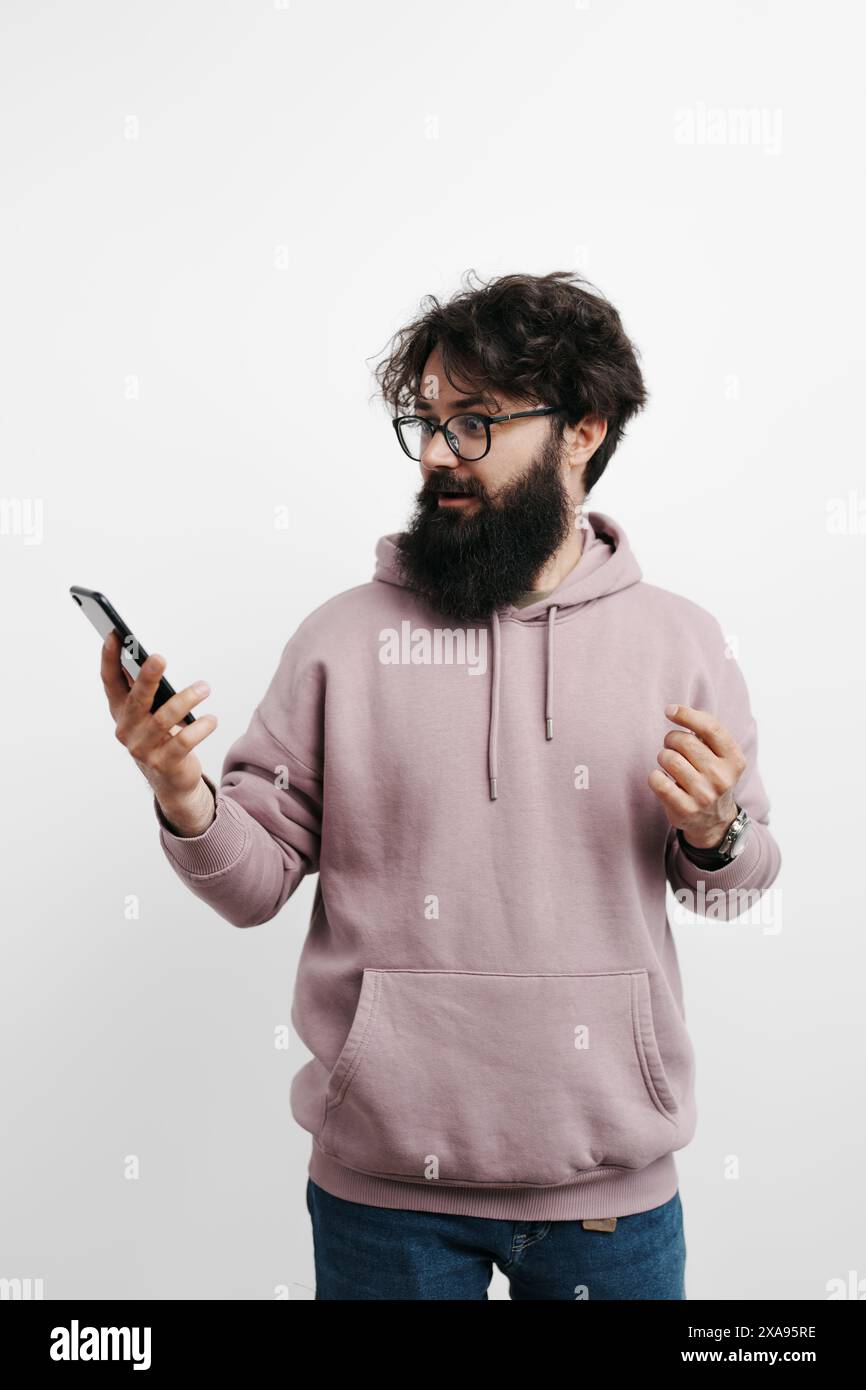 Young man engaged smartphone standing hi-res stock photography and ...