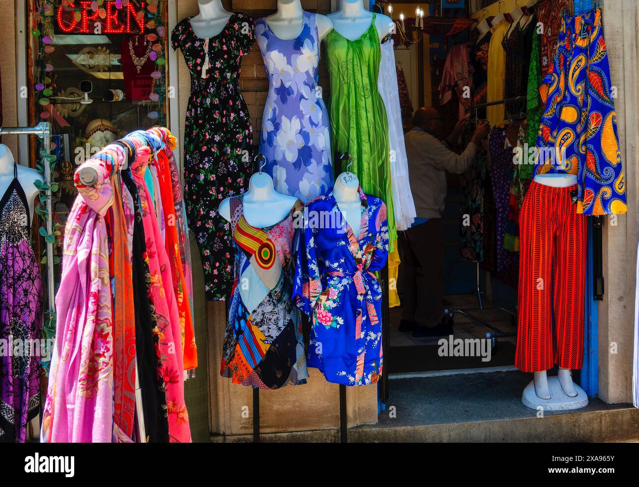 Colorful women's dresses ouside a boutque Stock Photo - Alamy