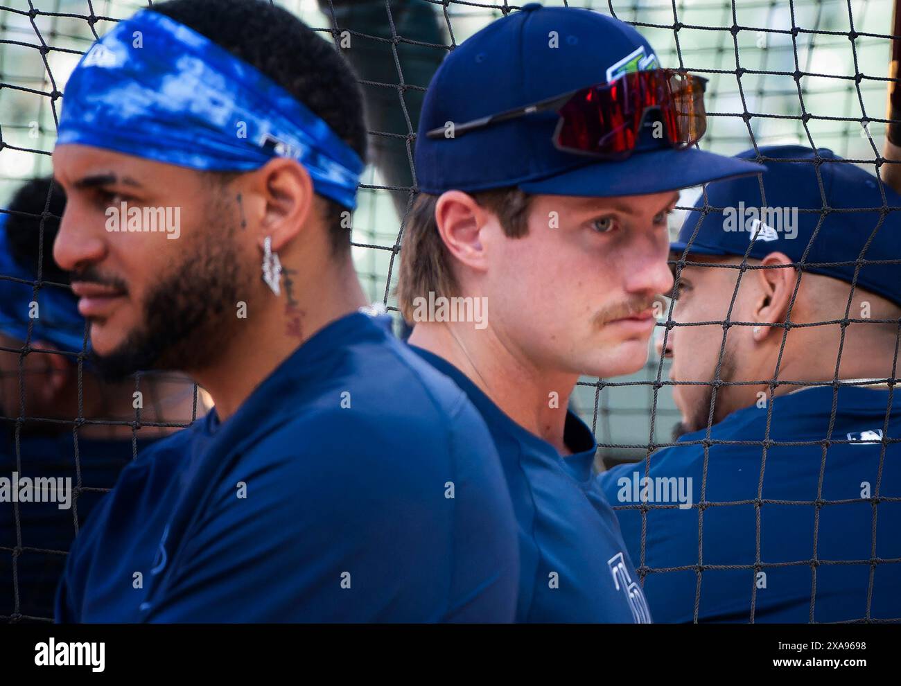 Three players at batting practice in a baseball stadium Stock Photo - Alamy