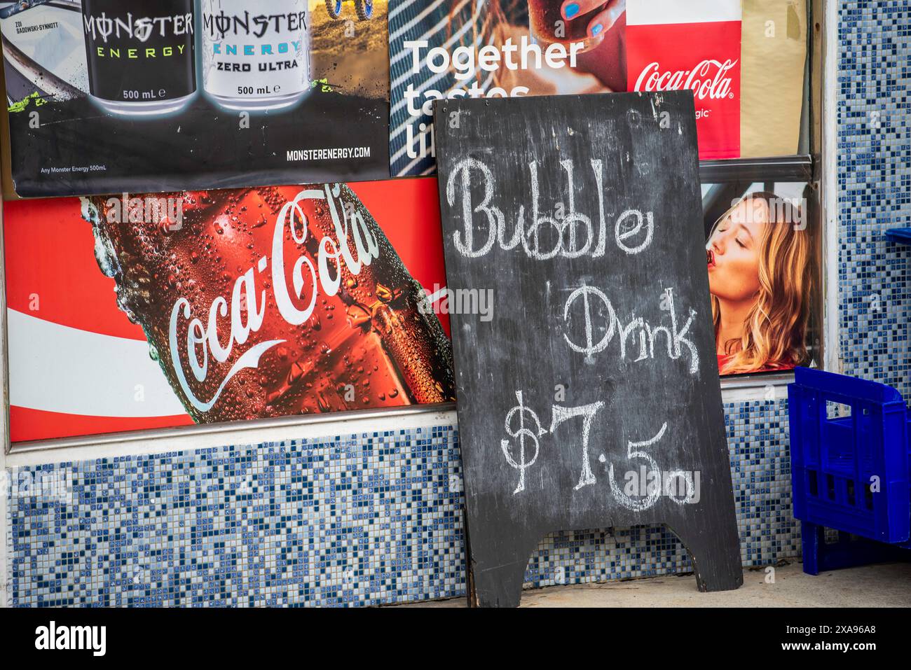 A hand written chalk board sign outside a New Zealand Dairy (corner ...