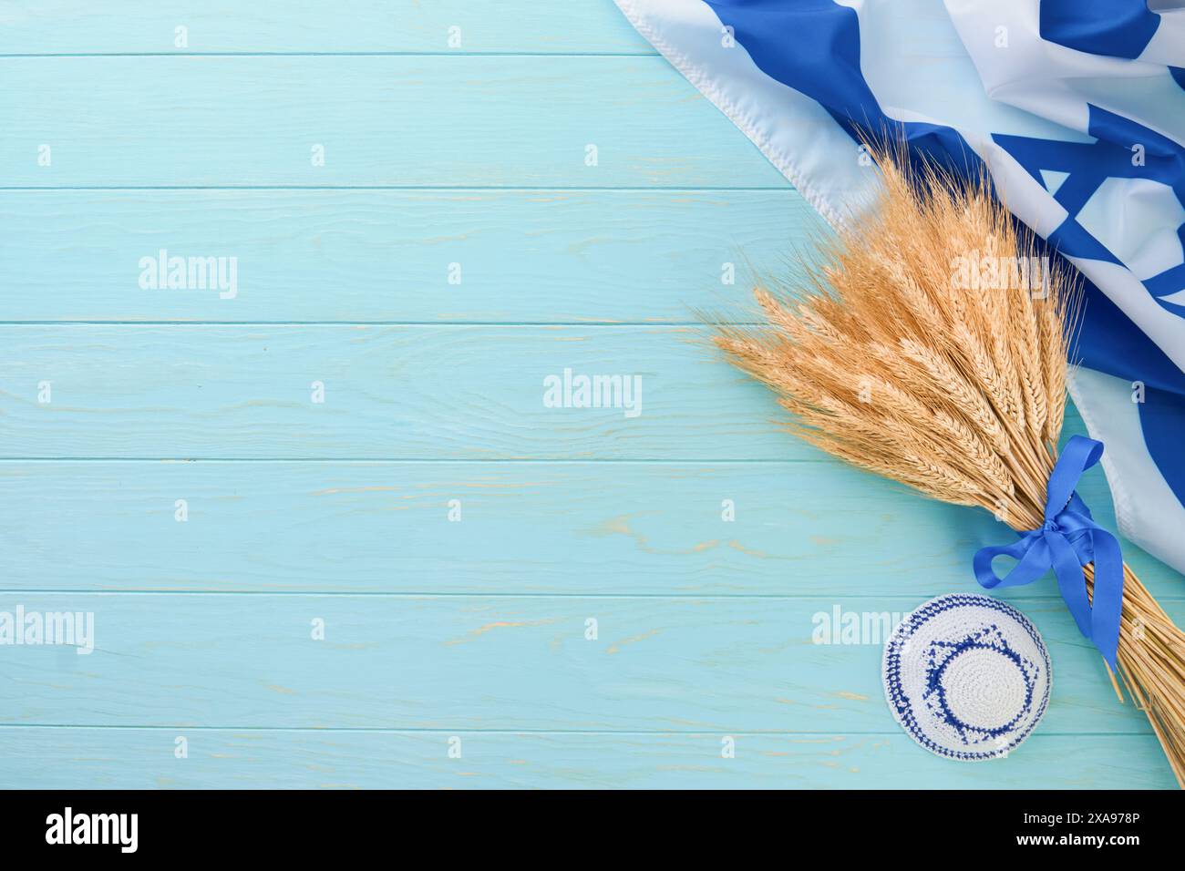 Shavuot jewish background. Ripe bouquet of wheat with blue ribbon with ...