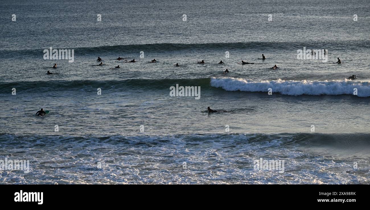 Swimmers in the ocean off the coastline along Praia do Zavial ...